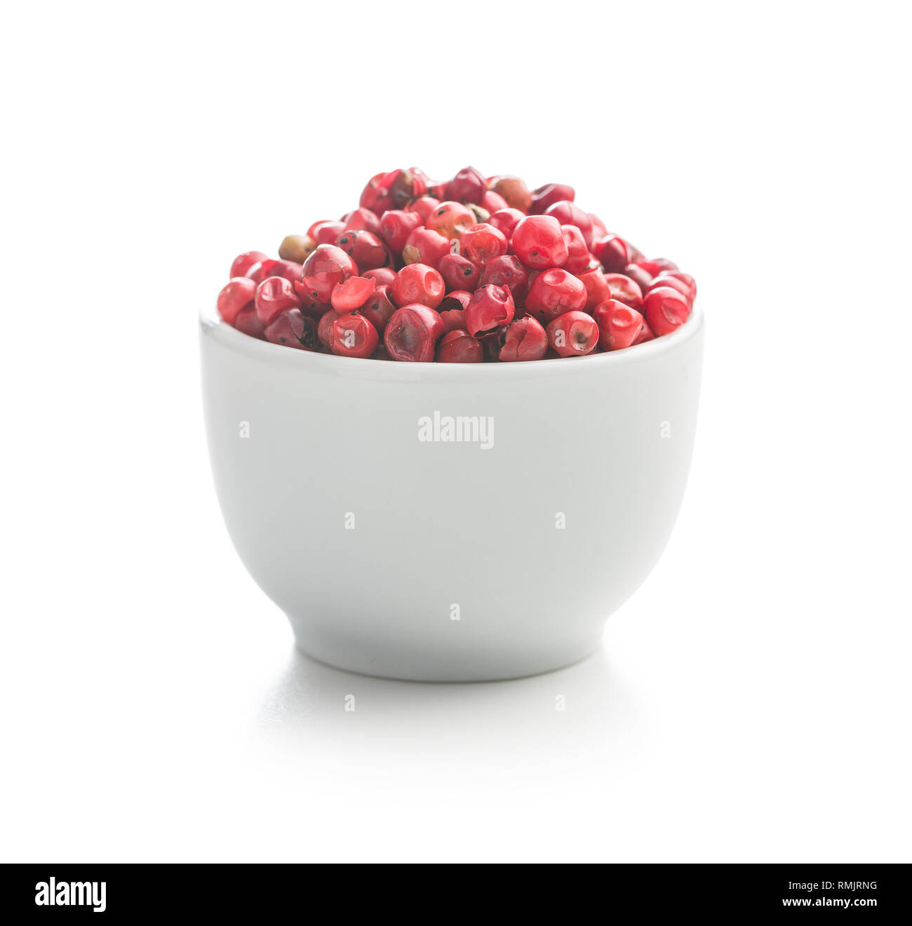 Dried pink peppercorn in bowl isolated on white background Stock Photo ...