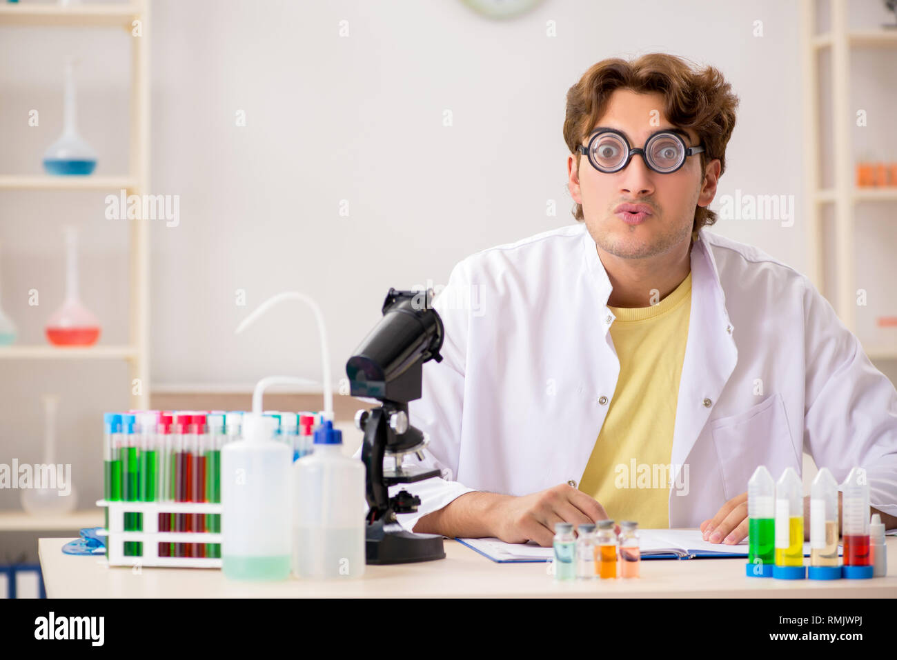 Funny crazy chemist doing experiments and tests Stock Photo - Alamy