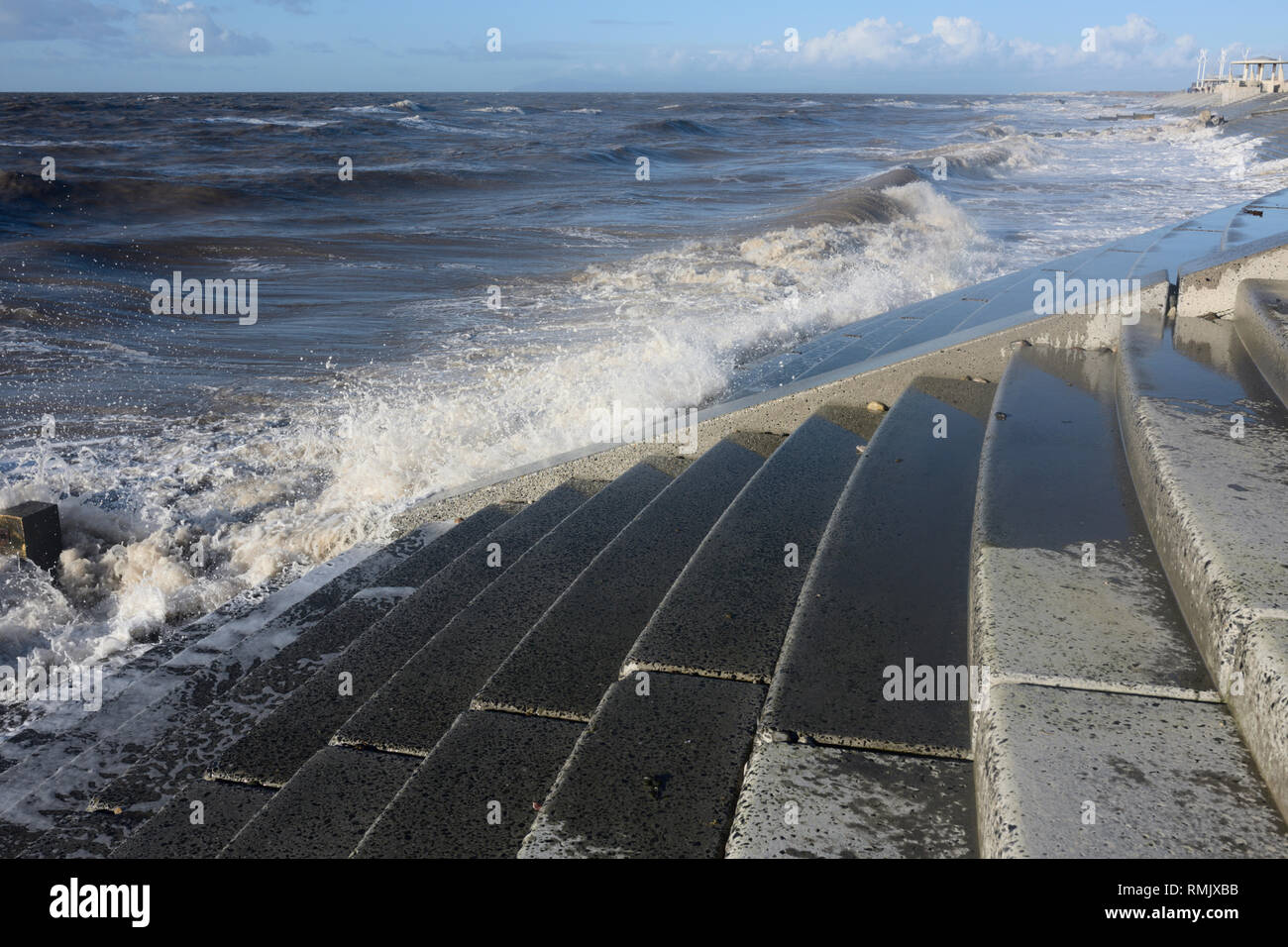 Waves from rough sea breaking on concrete stepped revetmet, protecting ...