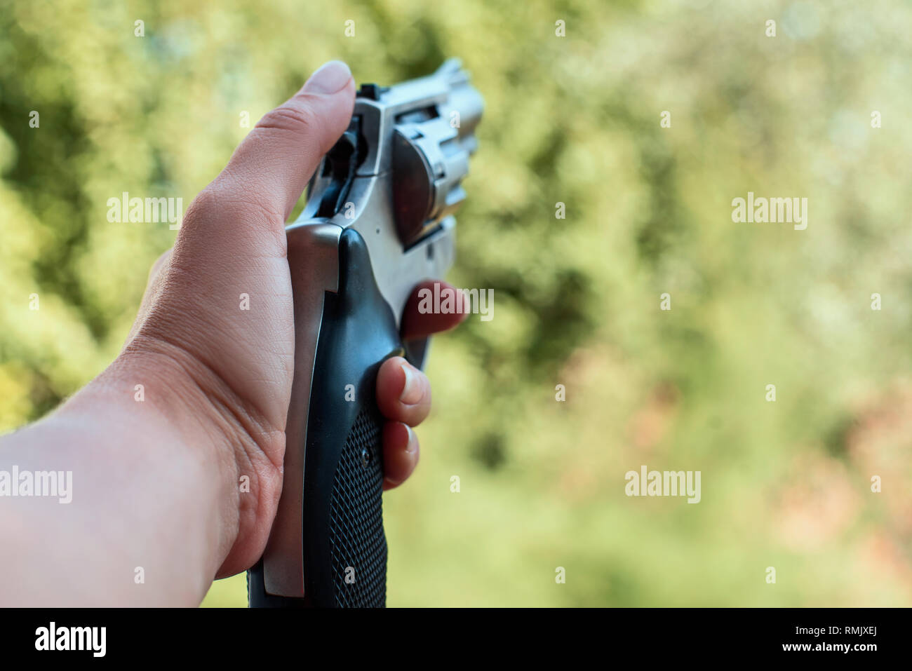 The girl is preparing to shoot.The concept of security. The gun in the ...