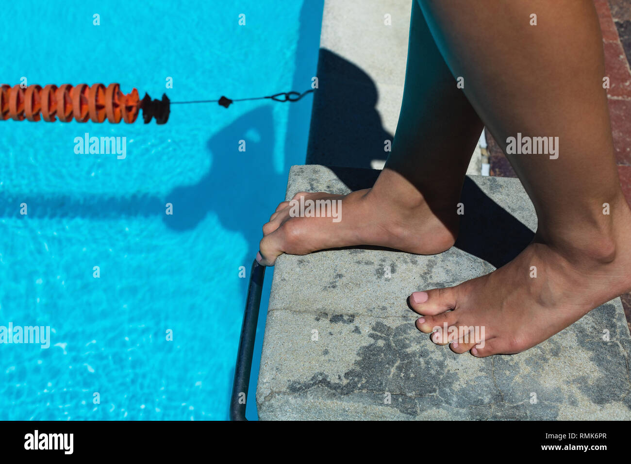 Young female swimmer standing on starting block Stock Photo - Alamy