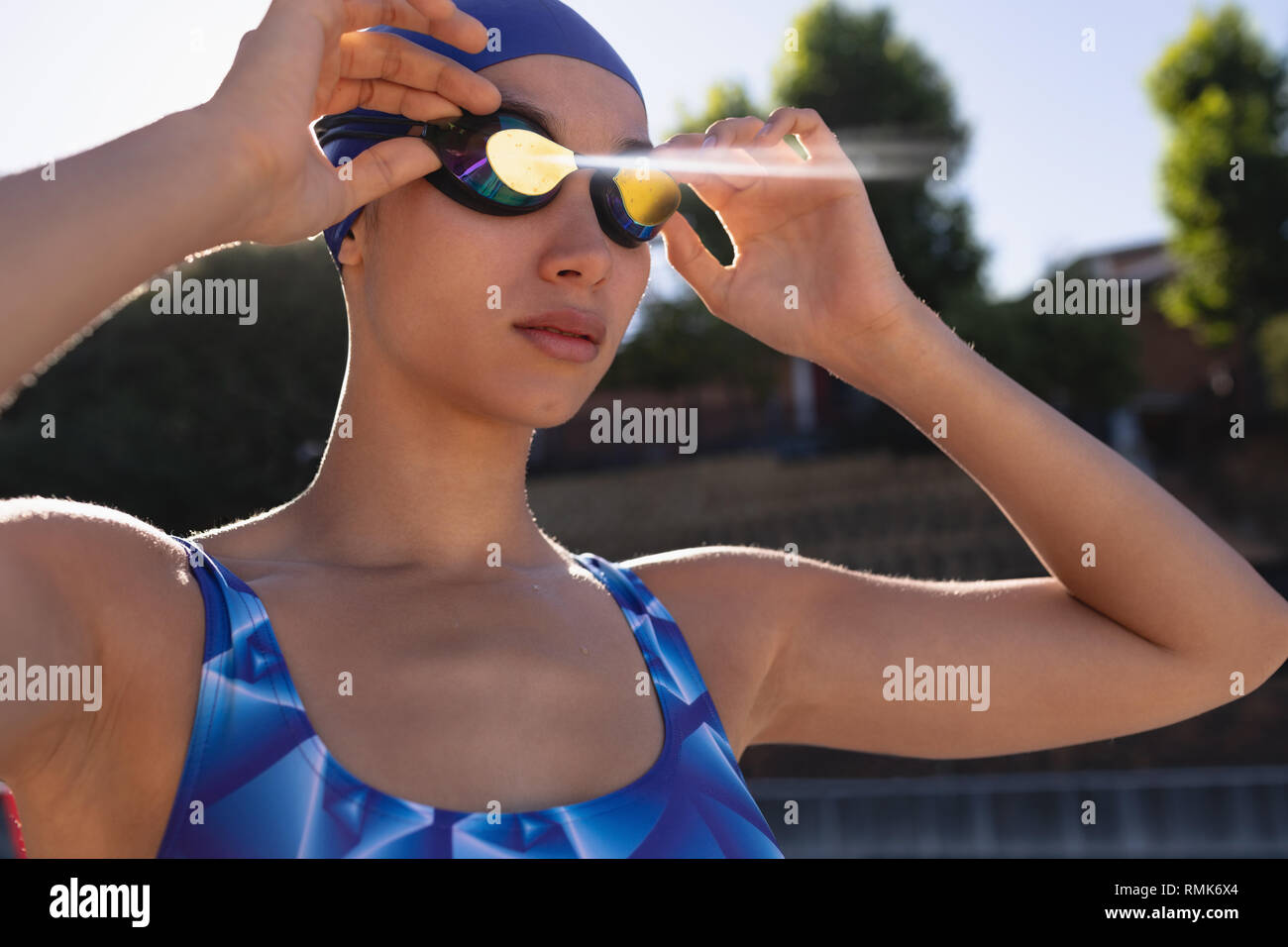 Female swimmer wearing her swim goggle Stock Photo - Alamy
