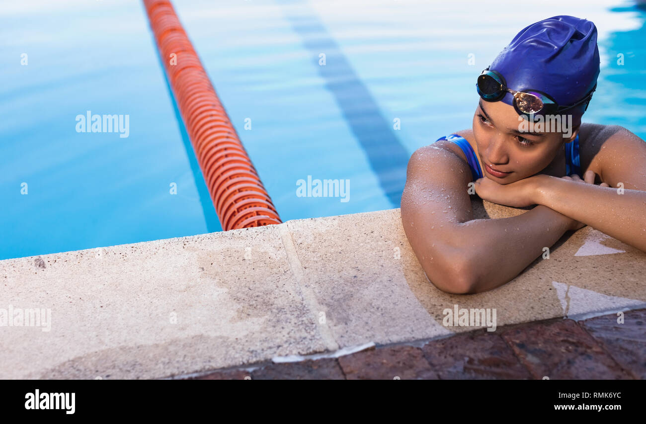 Female swimmer waiting on the edge of the swimming pool Stock Photo - Alamy