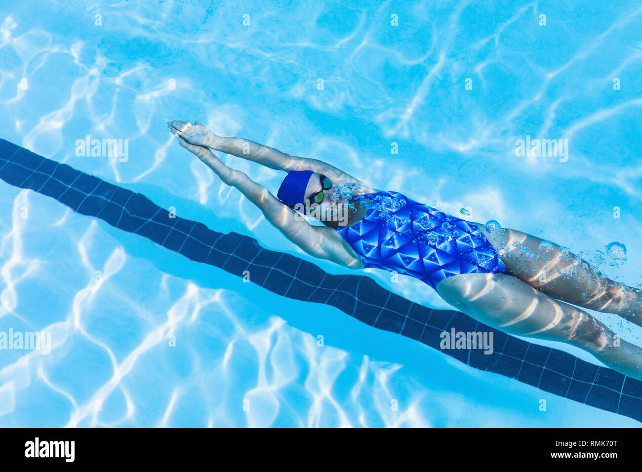 Female swimmer swimming backstroke in swimming pool Stock Photo - Alamy