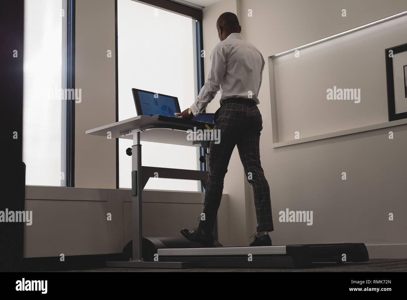 Professional man walking laptop computer hi-res stock photography and ...