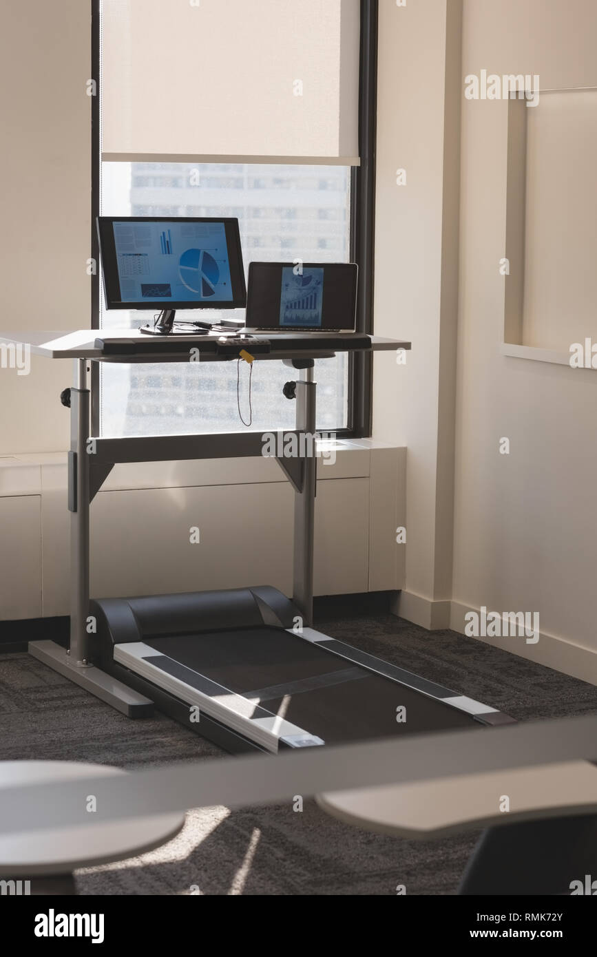 Modern office with treadmill Stock Photo - Alamy