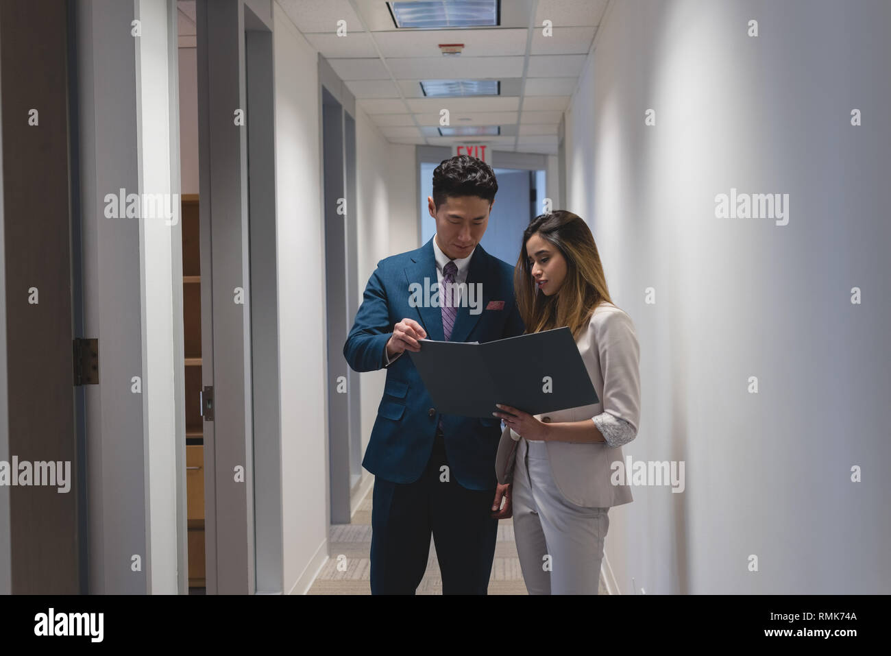 People discussing over file Stock Photo - Alamy