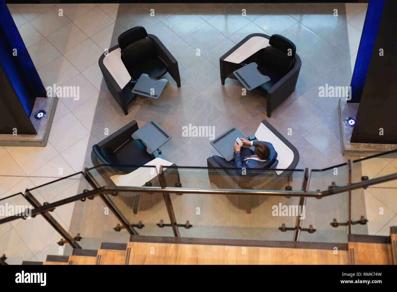 Man using mobile phone in the lobby Stock Photo - Alamy