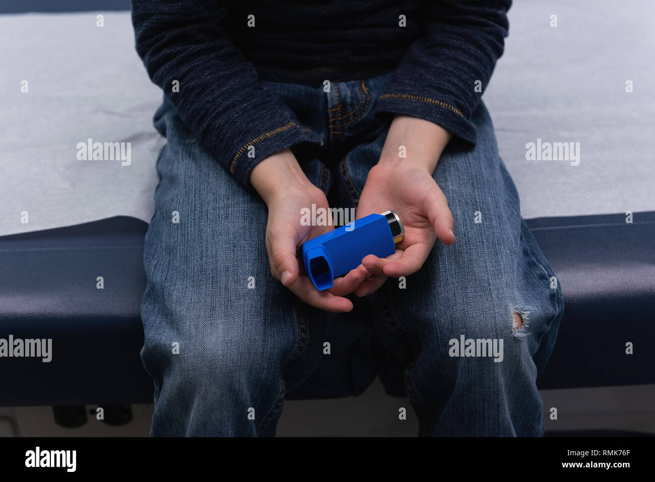 Caucasian boy patient is holding asthma inhaler in clinic Stock Photo ...
