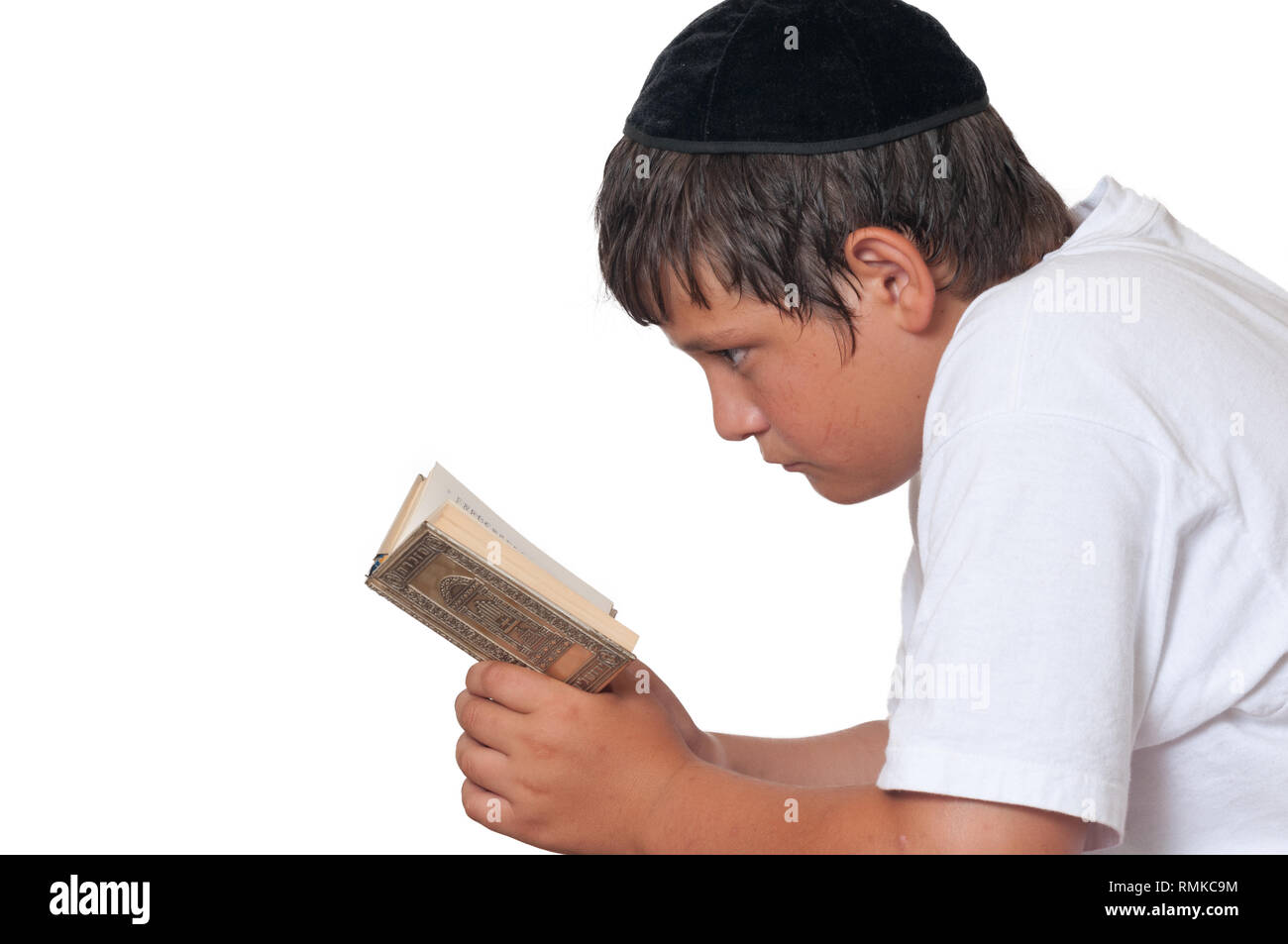 Jewish boy reading his Torah or prayer book isolated on white Stock ...
