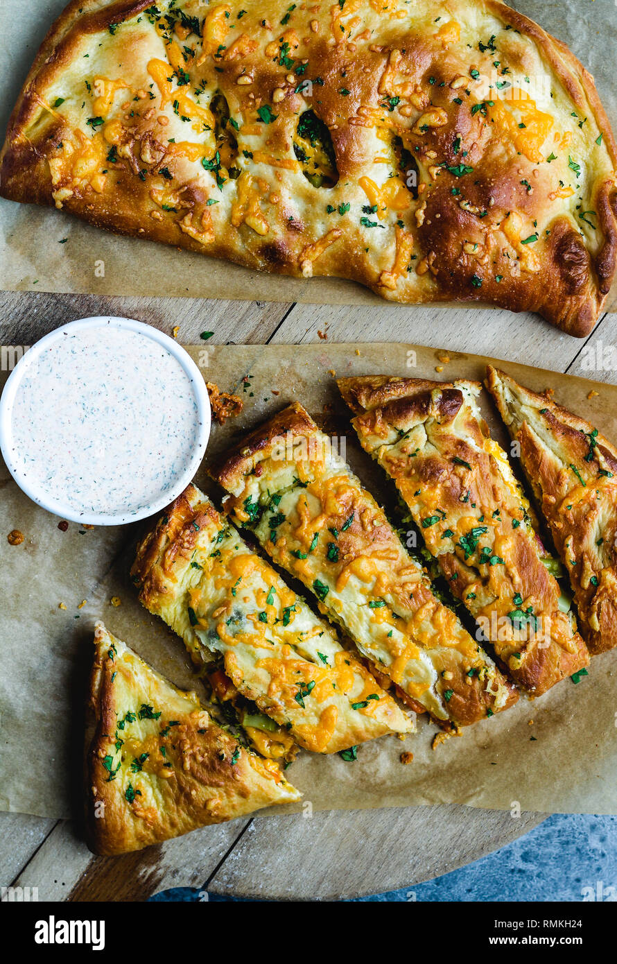 Broccoli cheddar calzone with spicy ranch Stock Photo - Alamy
