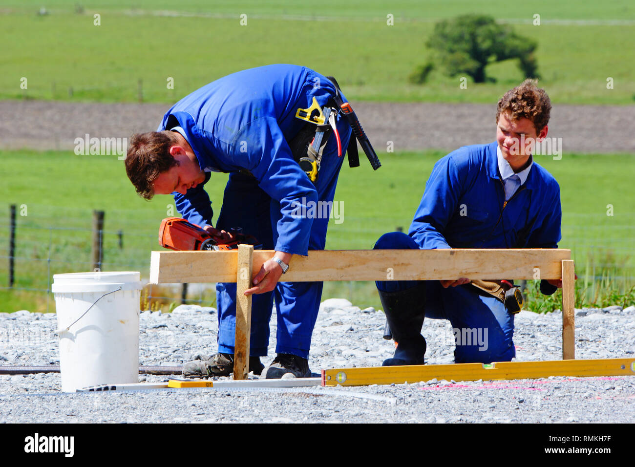 Builders mark out the profile for a building at a construction site in ...