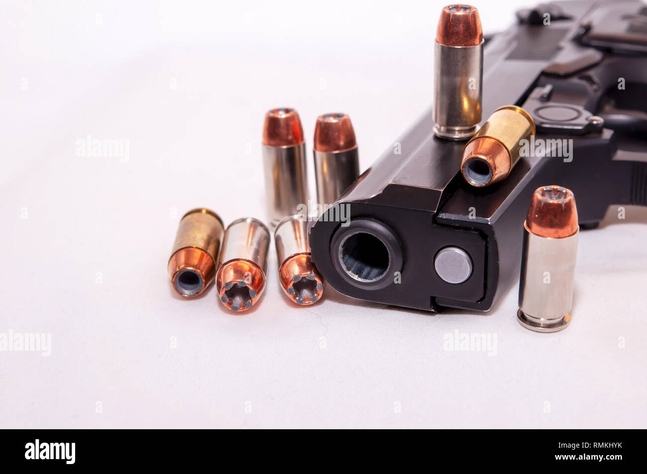 A black 40 caliber pistol with eight 40 caliber hollow point bullets on ...