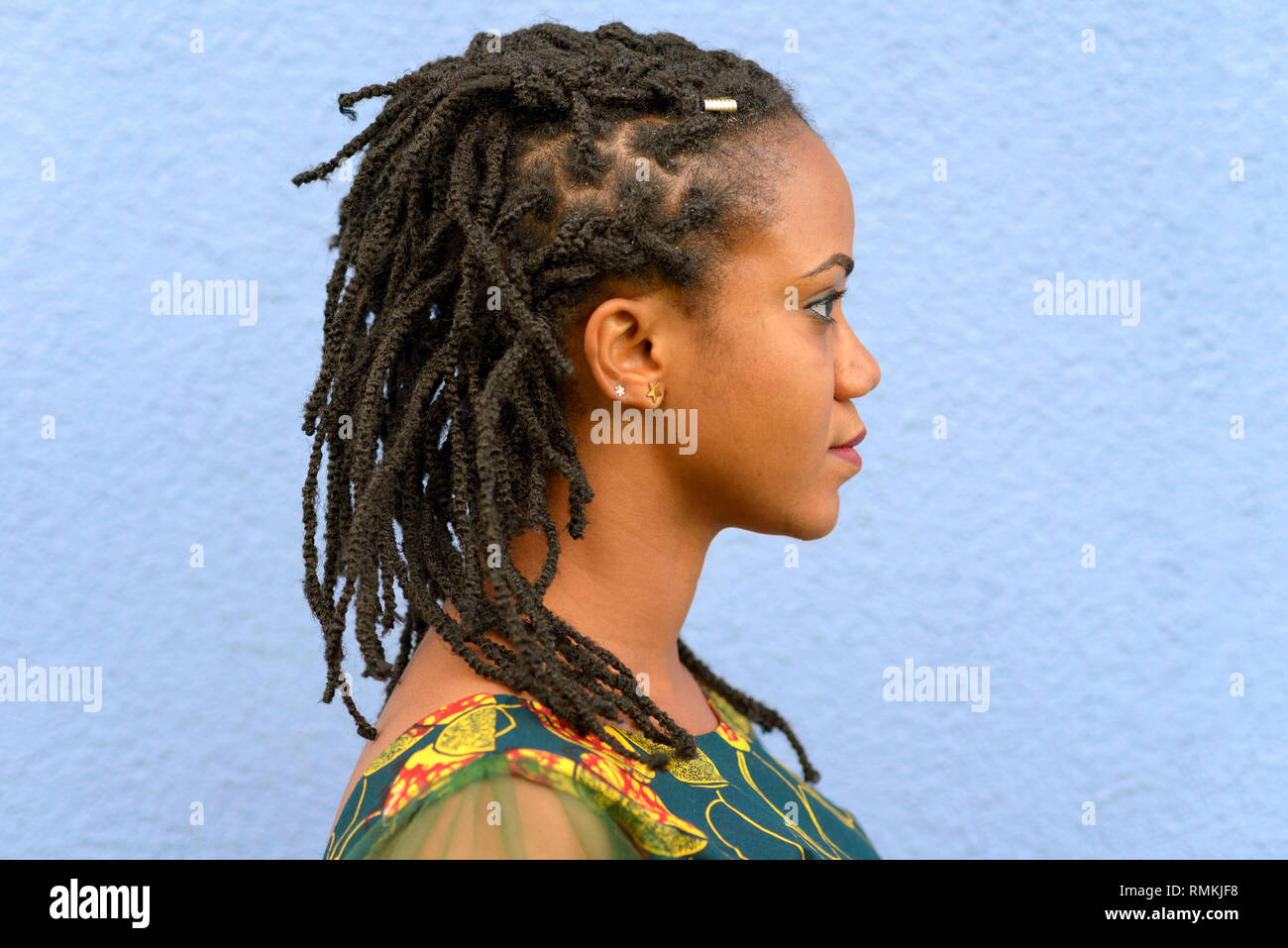 Side view head shot portrait of a pretty young African American woman ...