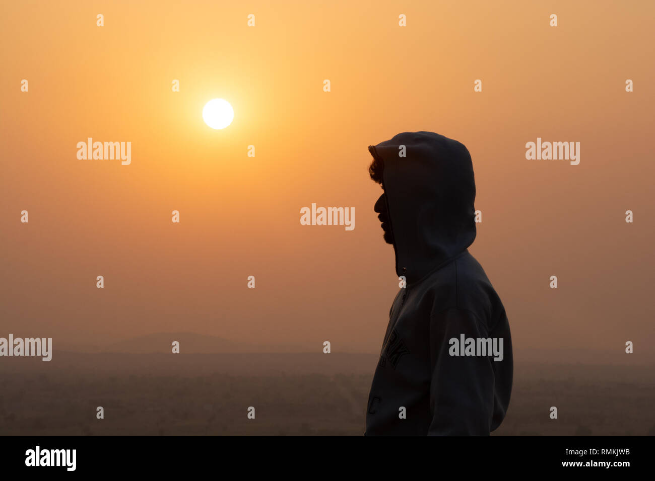 Close up of a person wearied hoody standing above the mountain with ...