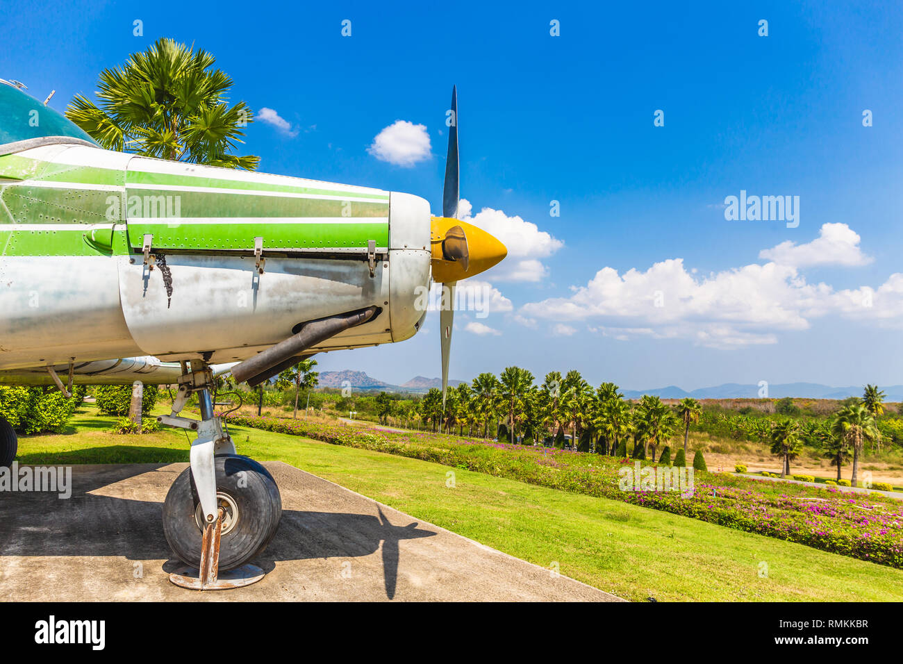 Colorful old airplane at park with gree tree and blue sky background ...