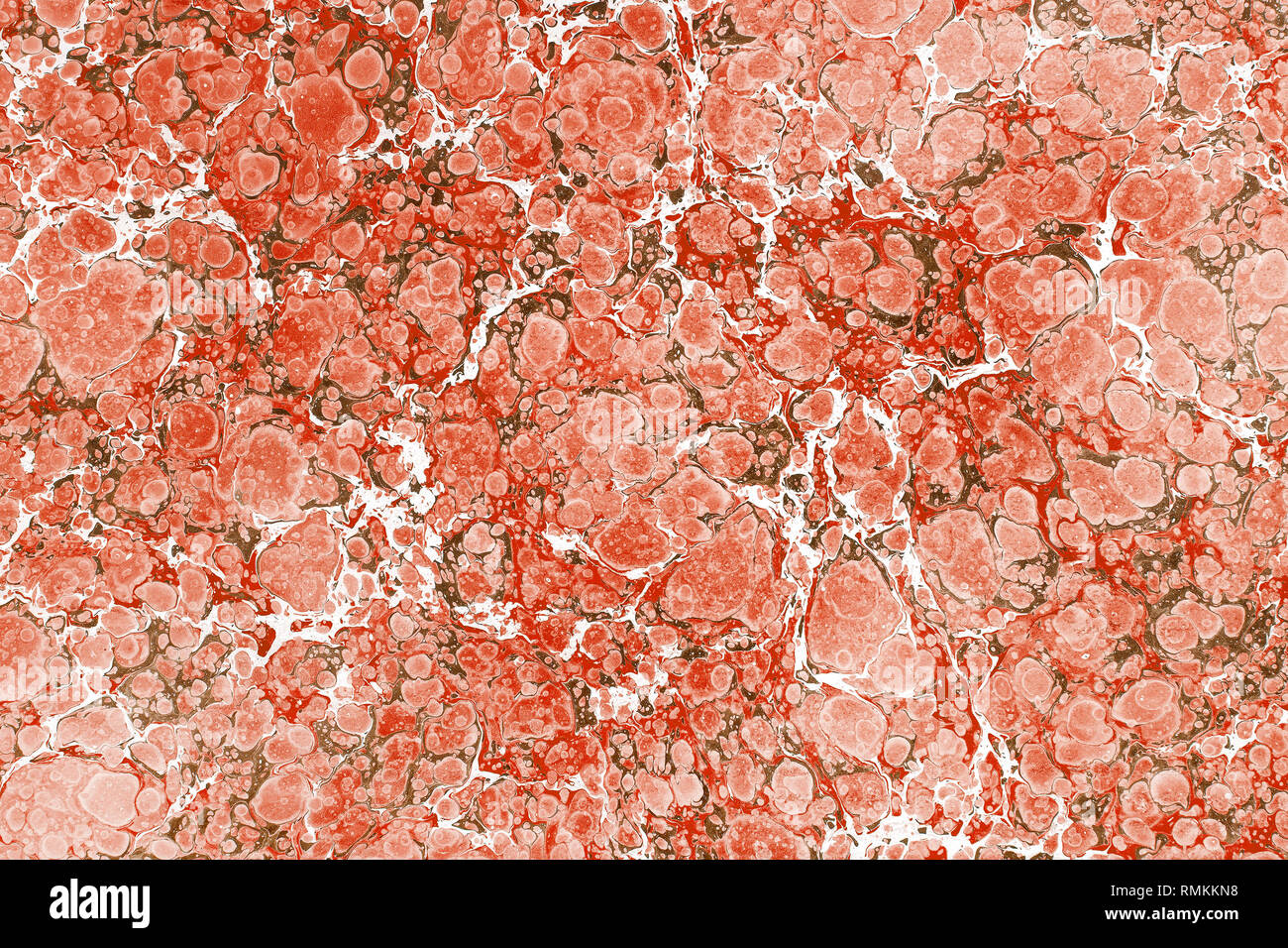 Stains of red liquid with white streaks on surface of paint or oil ...