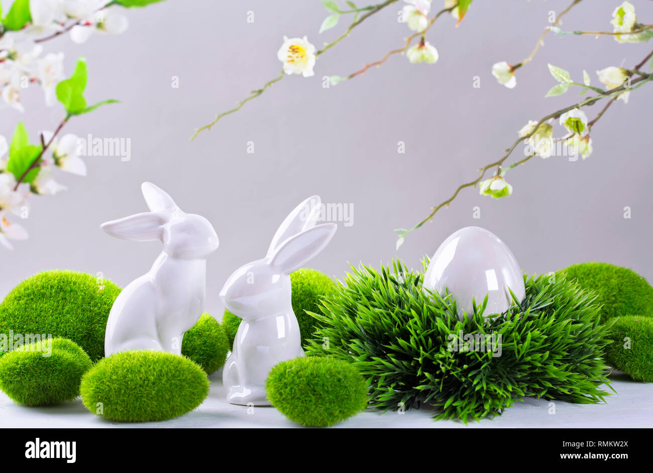 Ceramic easter rabbits and egg on a grey background Stock Photo - Alamy