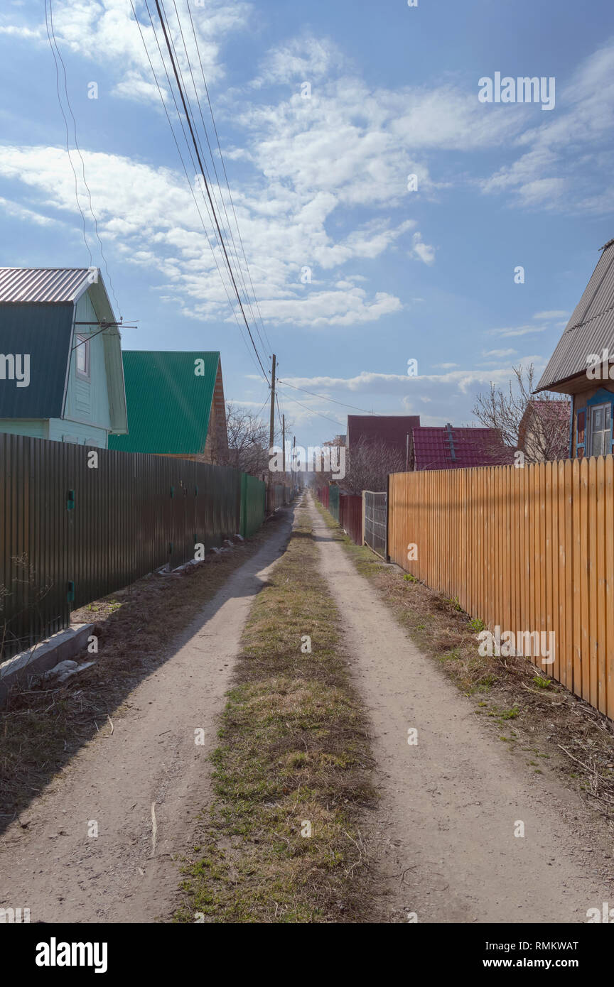 typical russian street with dachas at countryside on sunny spring day ...