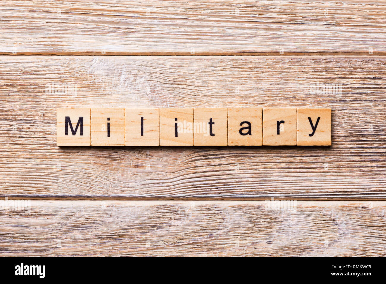 MILITARY word written on wood block. MILITARY text on wooden table for ...