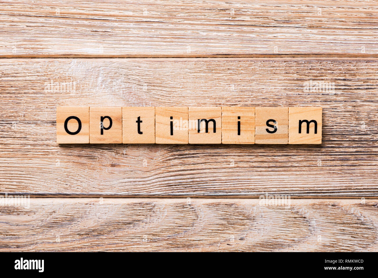 Optimism word written on wood block. Optimism text on wooden table for ...