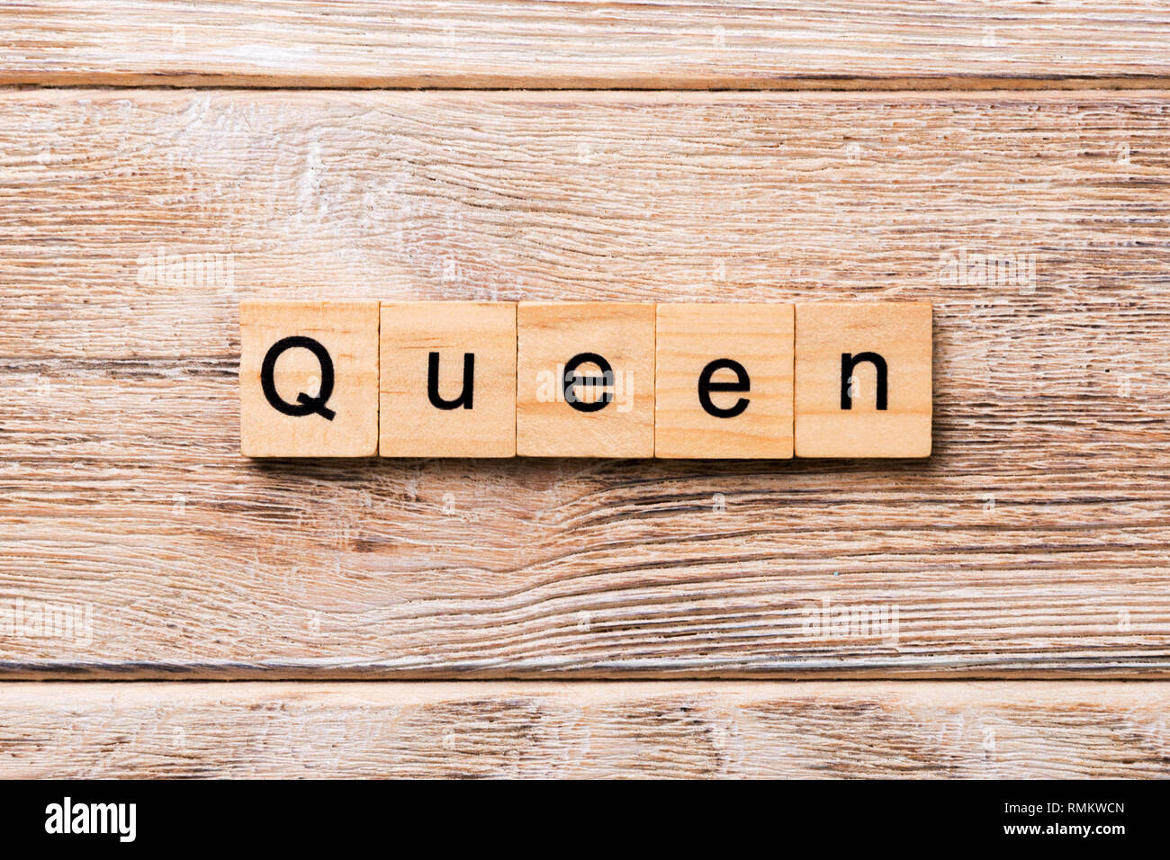 queen word written on wood block. queen text on wooden table for your ...