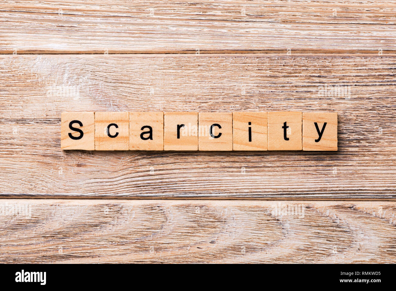 scarcity word written on wood block. scarcity text on wooden table for ...