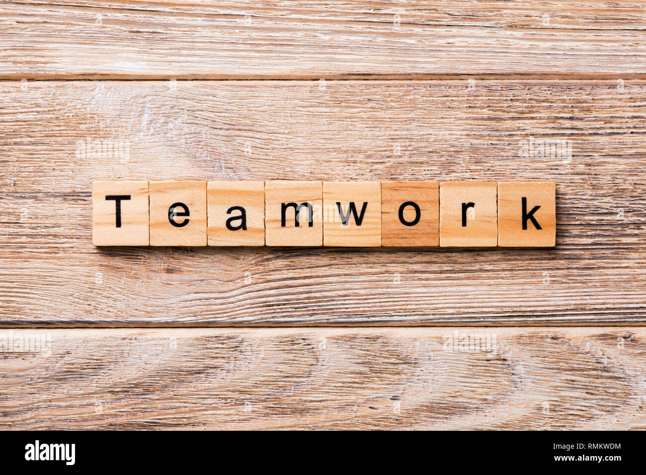 TEAMWORK word written on wood block. TEAMWORK text on wooden table for ...