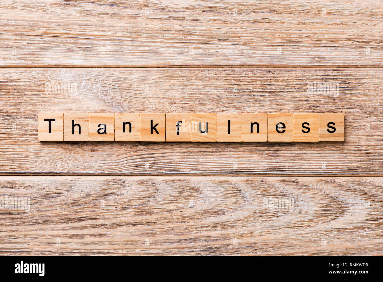 Thankfulness word written on wood block. Thankfulness text on wooden ...