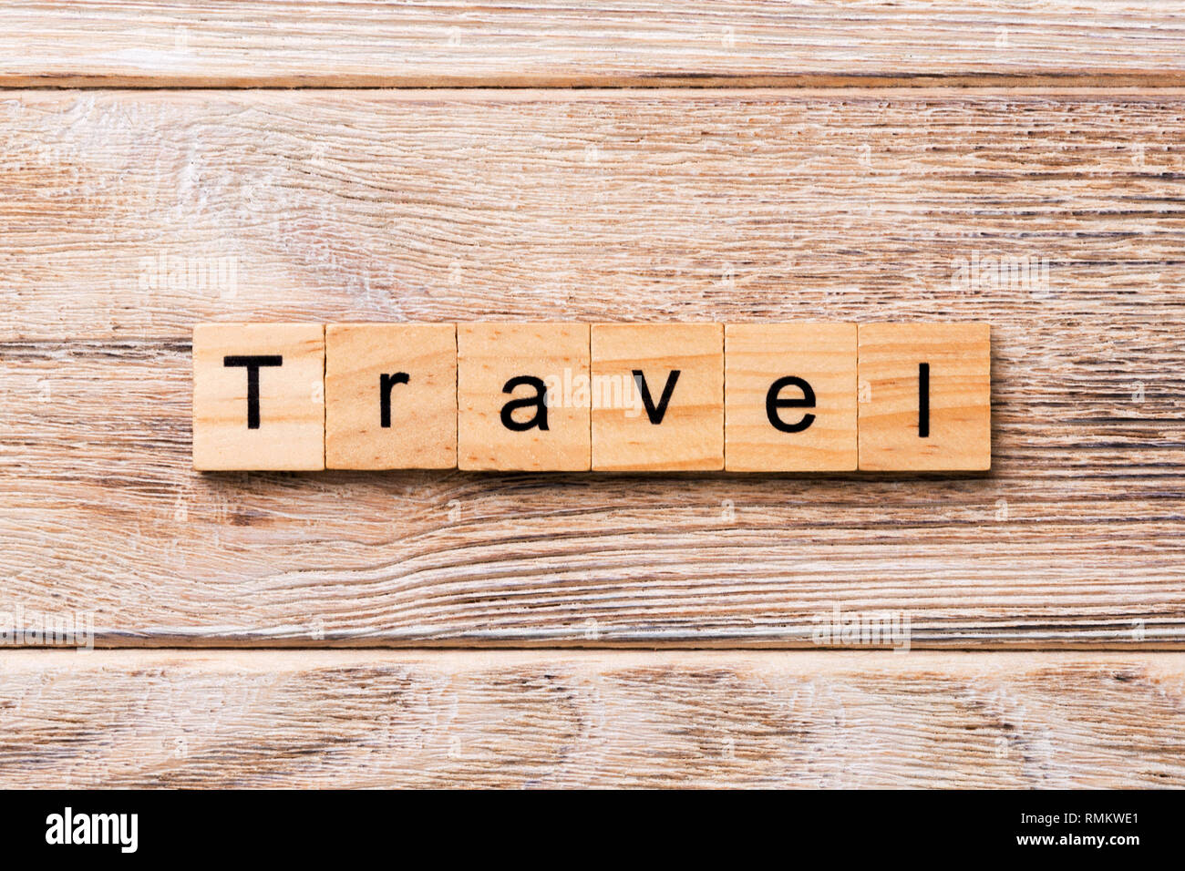 Travel word written on wood block. Travel text on wooden table for your ...