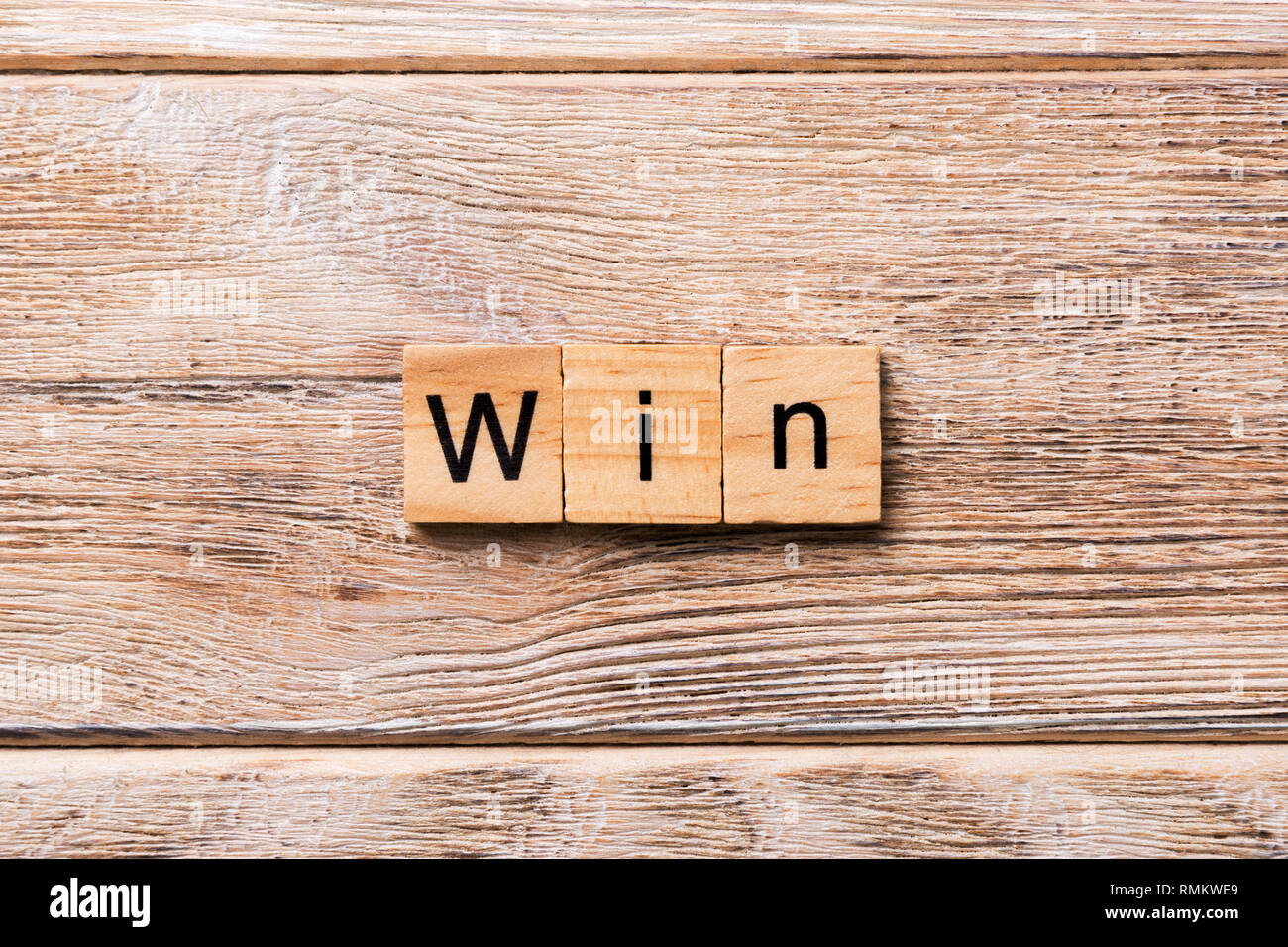 WIN word written on wood block. WIN text on wooden table for your ...