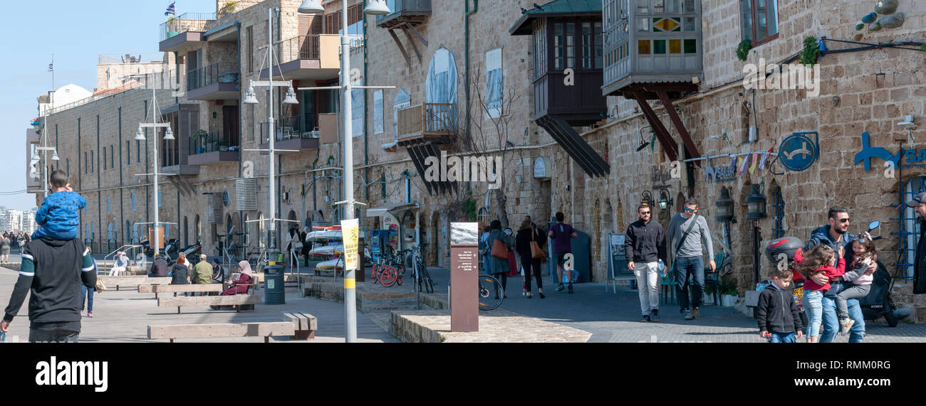 Israel, Old Jaffa Port, visitors walk along the pier. The ancient port ...