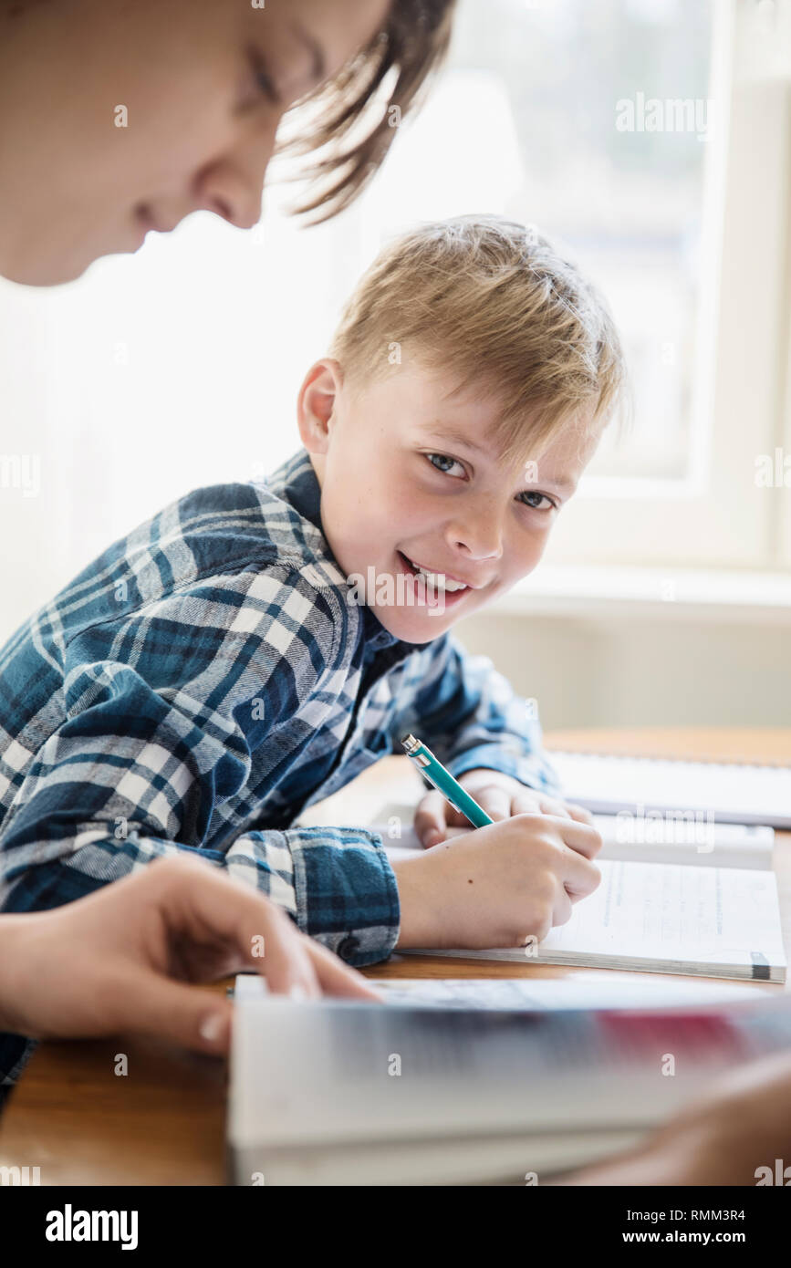 Brothers doing homework Stock Photo - Alamy