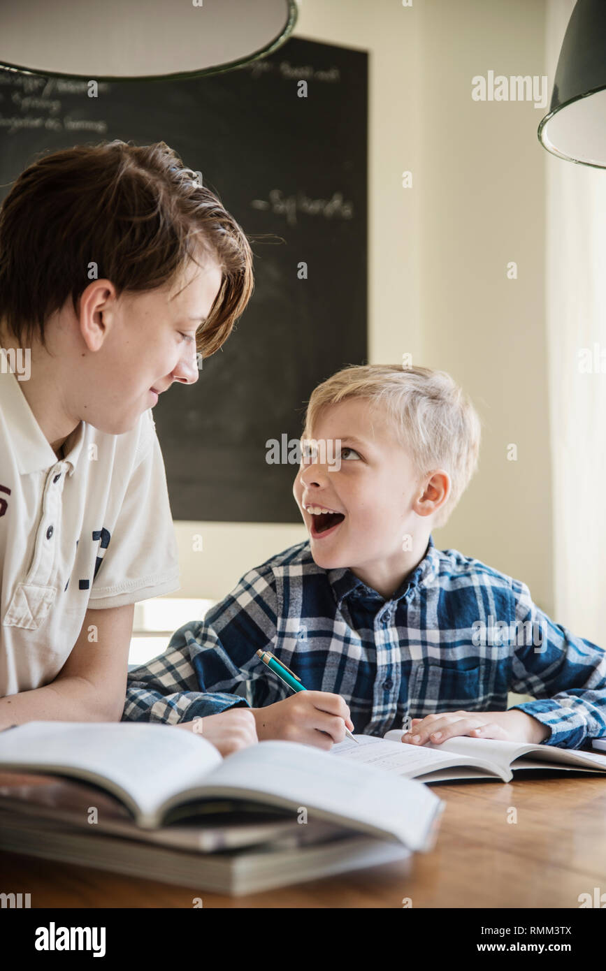 Brothers doing homework Stock Photo - Alamy