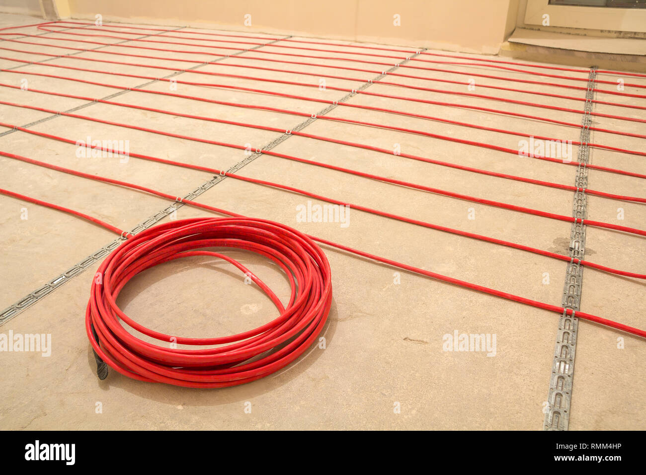 Heating red electrical cable wire roll on cement floor copy space ...