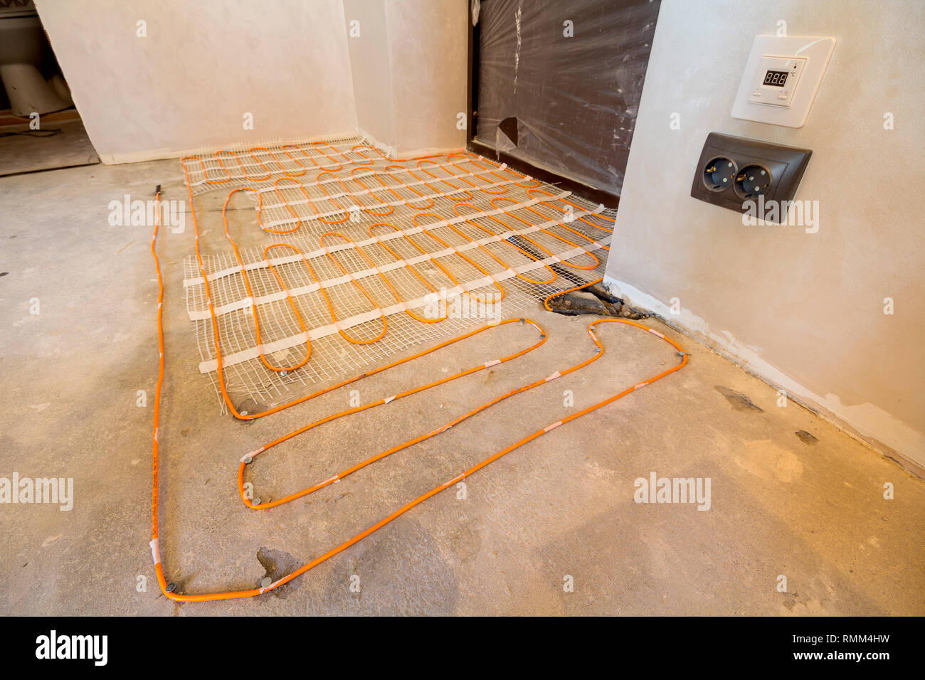 Heating red electrical cable wire system installed on cement floor in ...