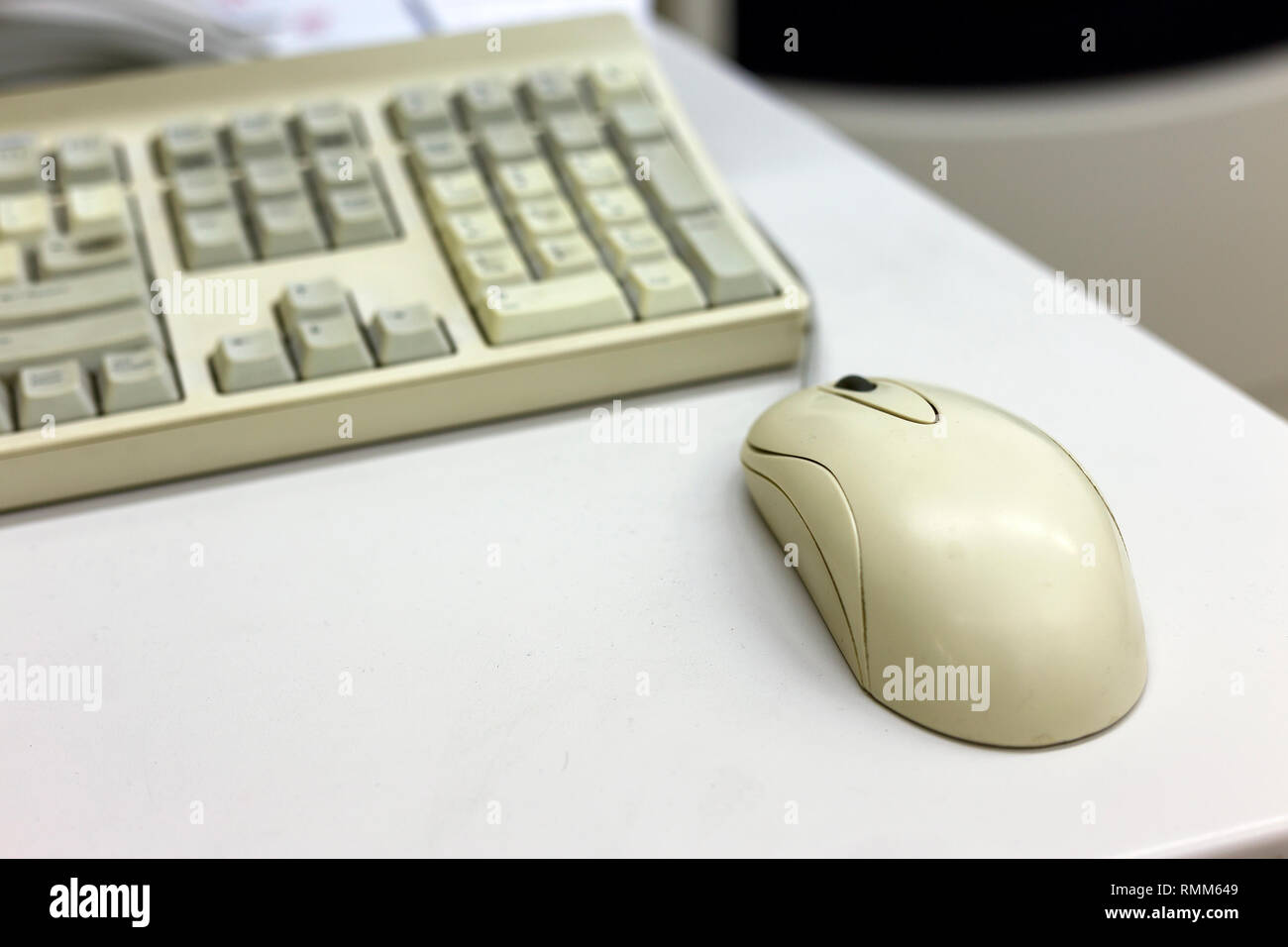 Close-up of white computer mouse on blurred PC keyboard background ...