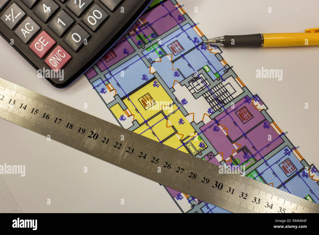 Top view of calculator, pen and ruler on blueprint plan of architecture ...