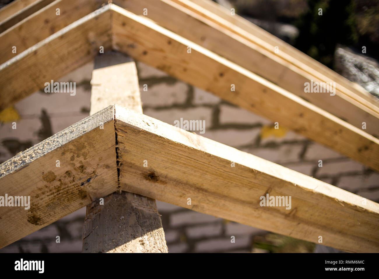 Close-up detail of roof frame of rough wooden lumber beams on ...