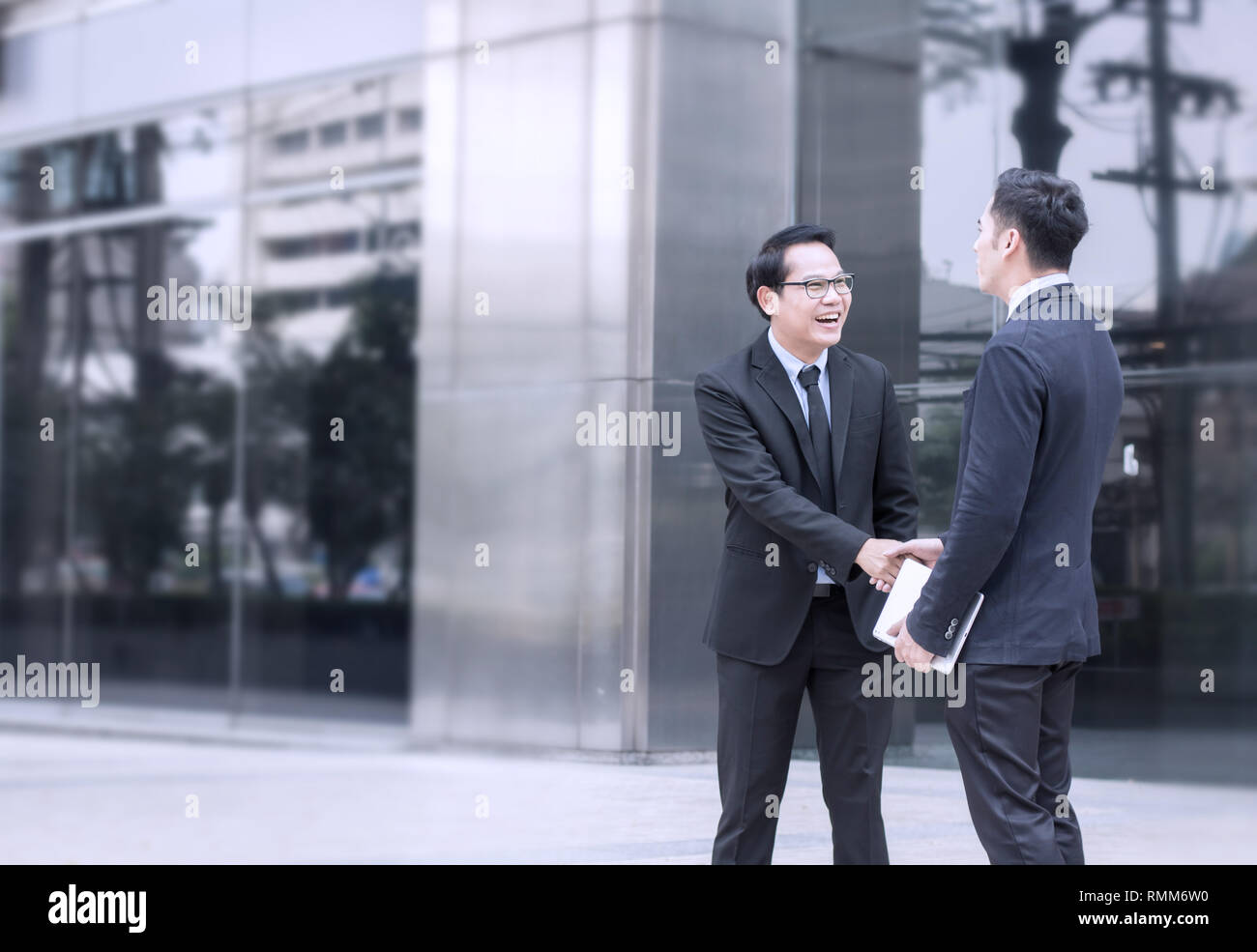 team of business people stand shaking hands, talking and discussing in ...