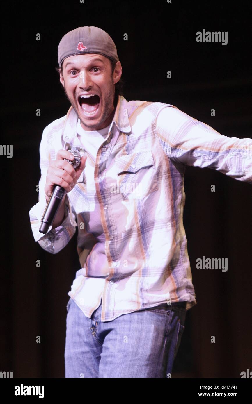Comedian Josh Wolf is shown performing on stage during a "live" concert ...