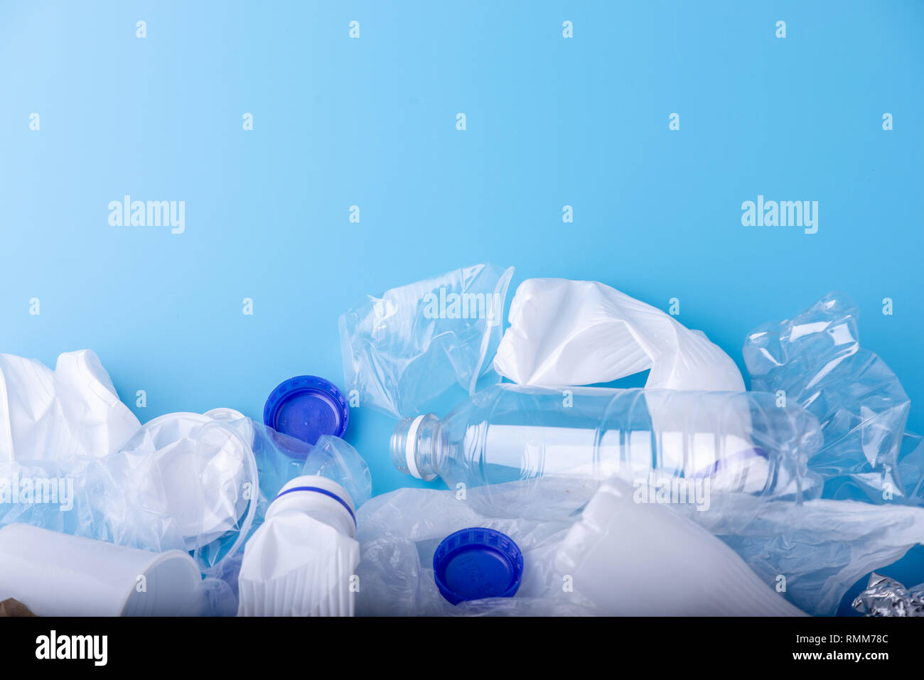 Used clean plastic garbage in a pile. Bottles and bags on blue ...