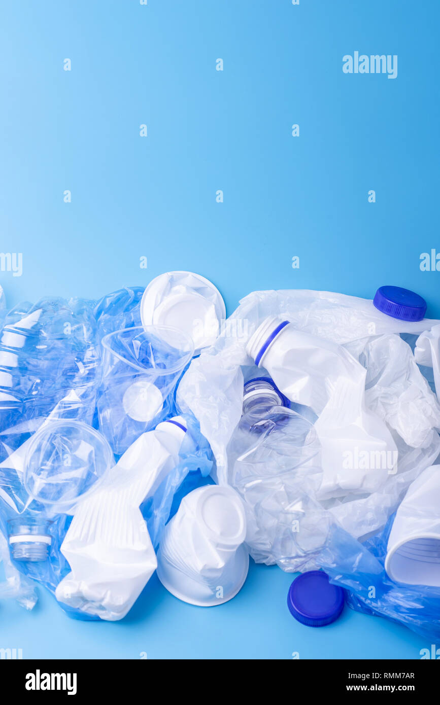 Used clean plastic garbage in a pile. Bottles and bags on blue ...