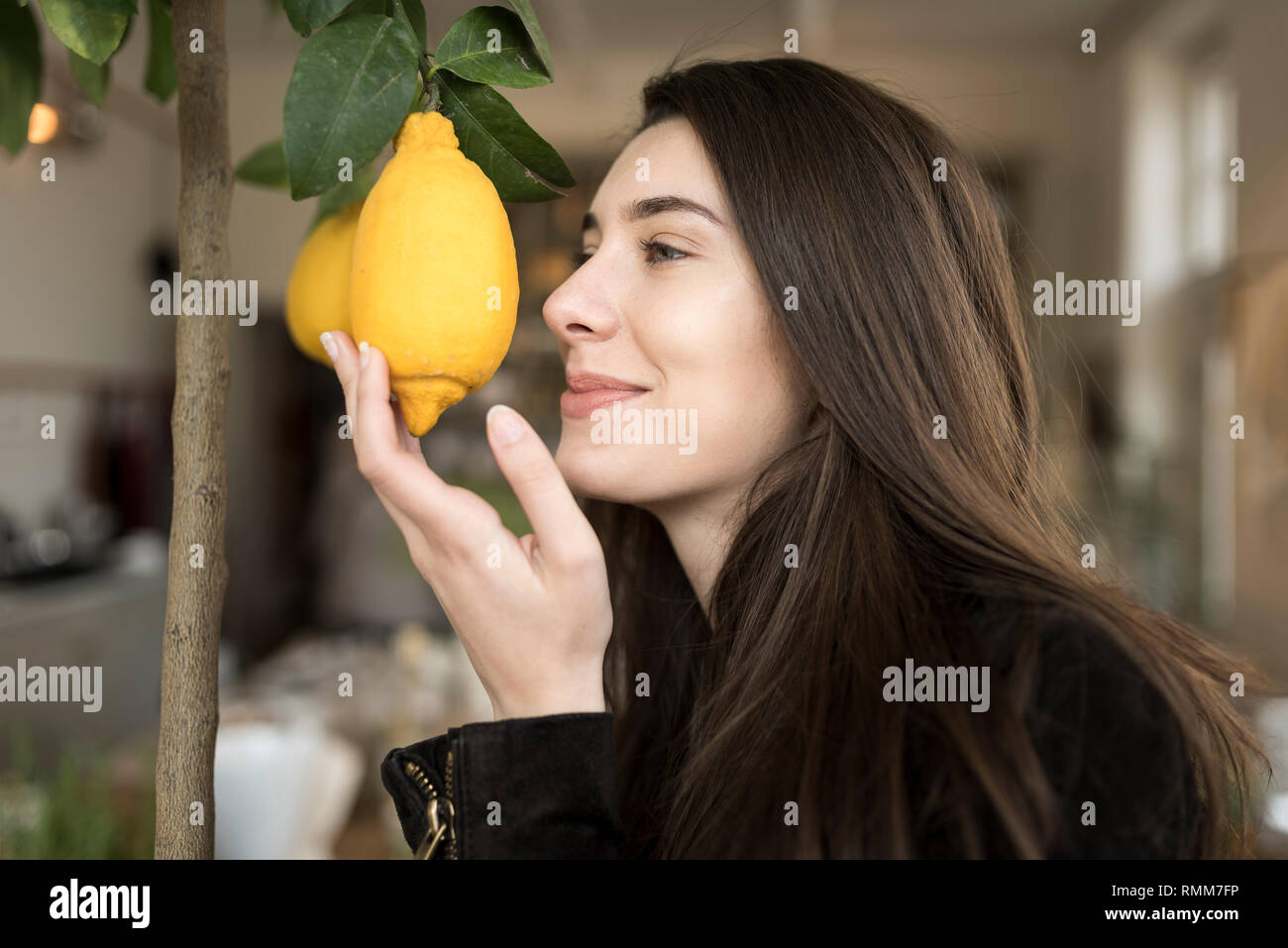 Young woman smelling lemon Stock Photo - Alamy