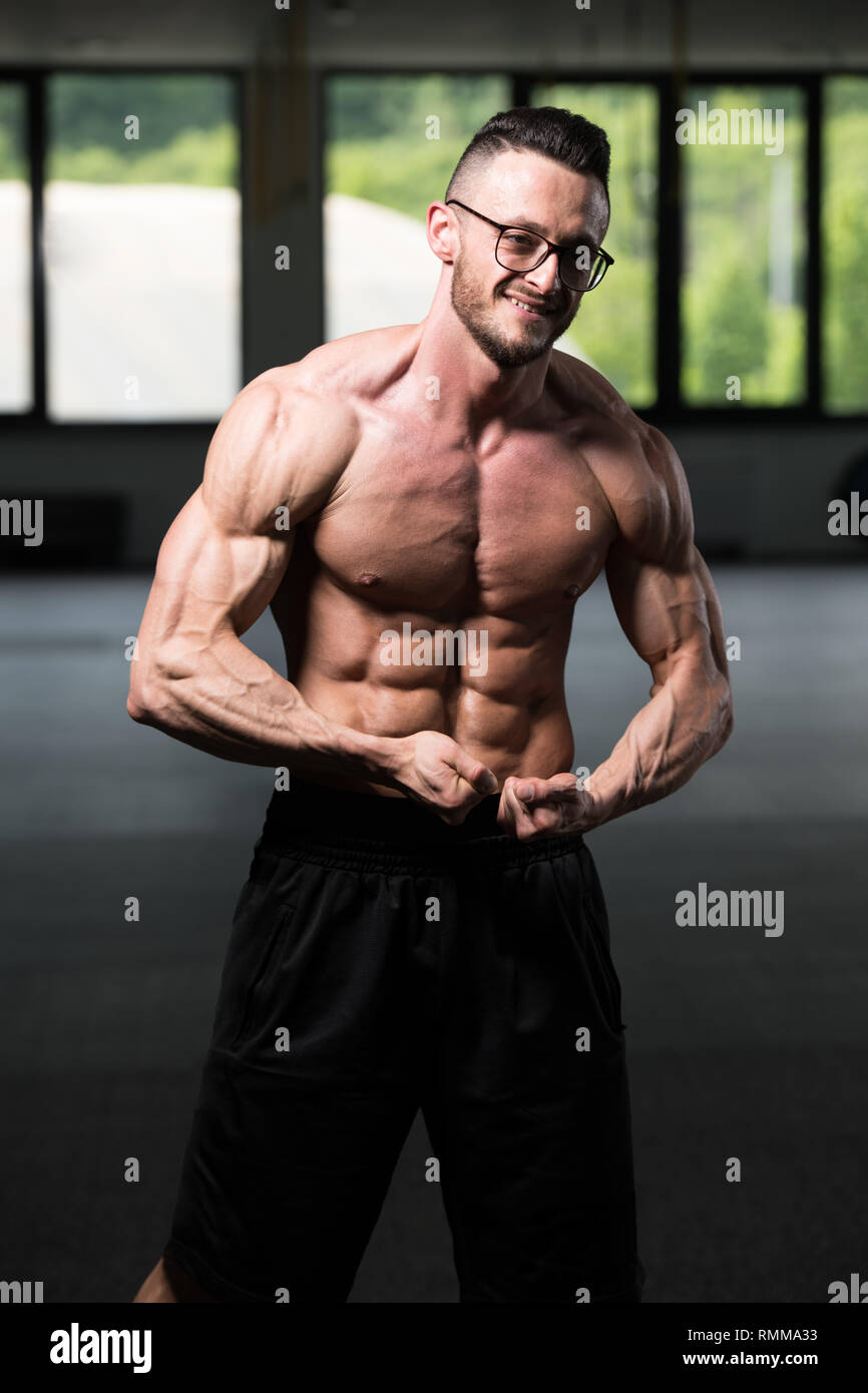 Portrait Of A Young Physically Fit Nerd Man Showing His Well Trained ...