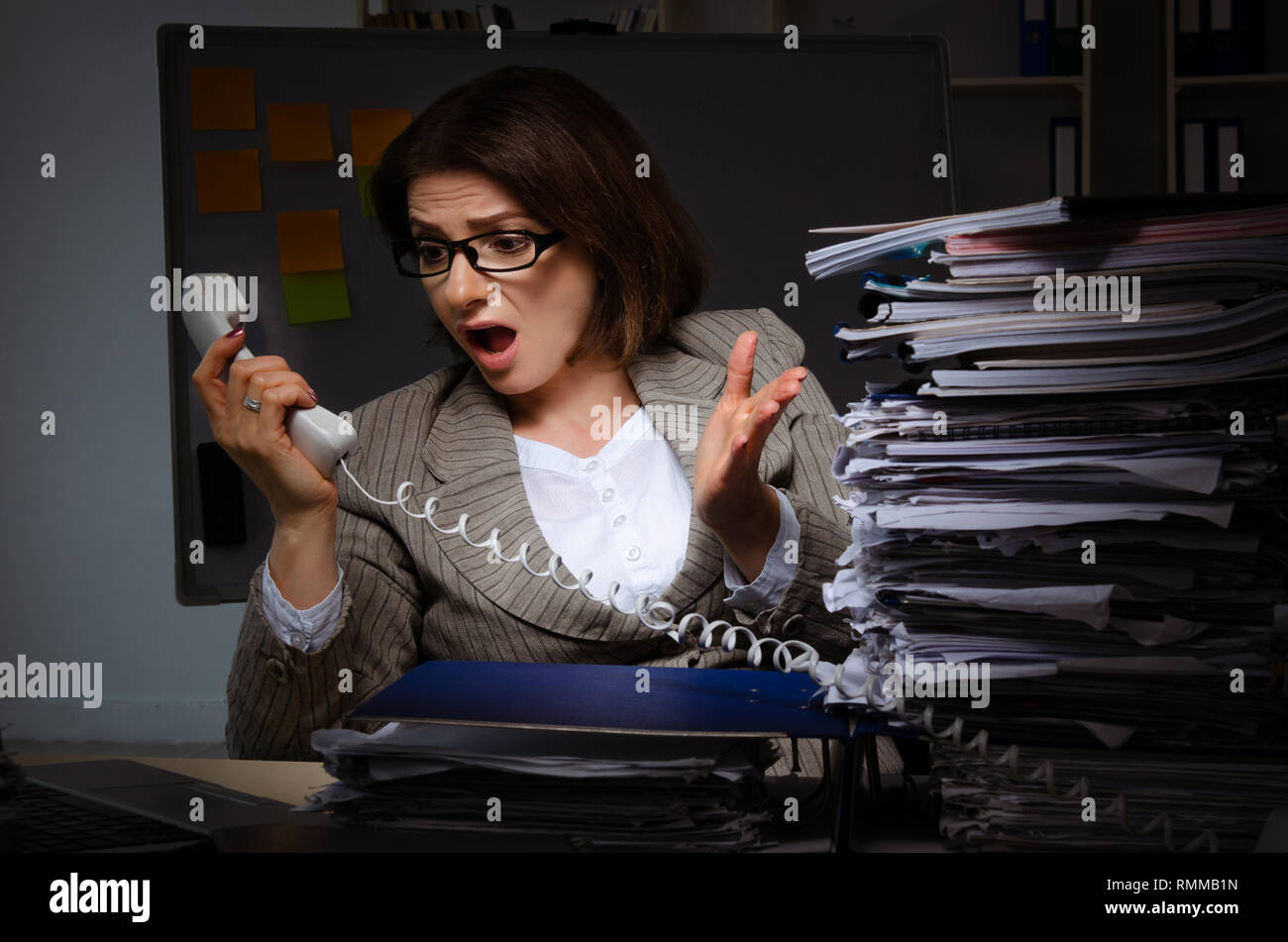 Female employee suffering from excessive work Stock Photo - Alamy