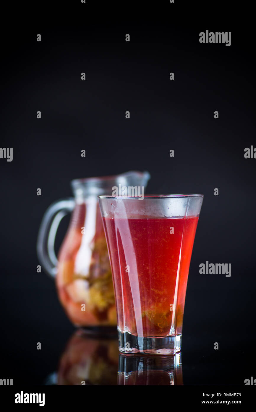 red fruit compote in a decanter with a glass Stock Photo - Alamy