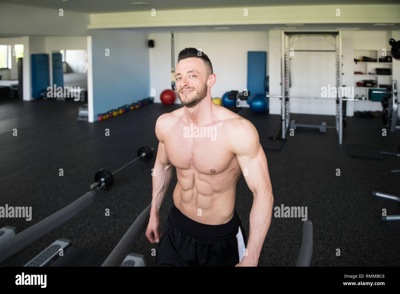 Healthy Man Running On Treadmill In A Modern Fitness Center Stock Photo ...