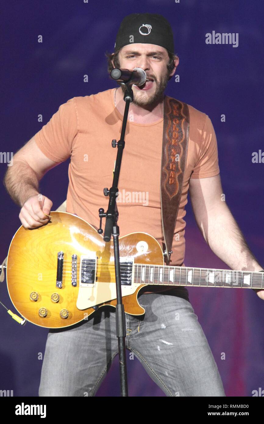Musician Thomas Rhett is shown performing on stage during a "live ...