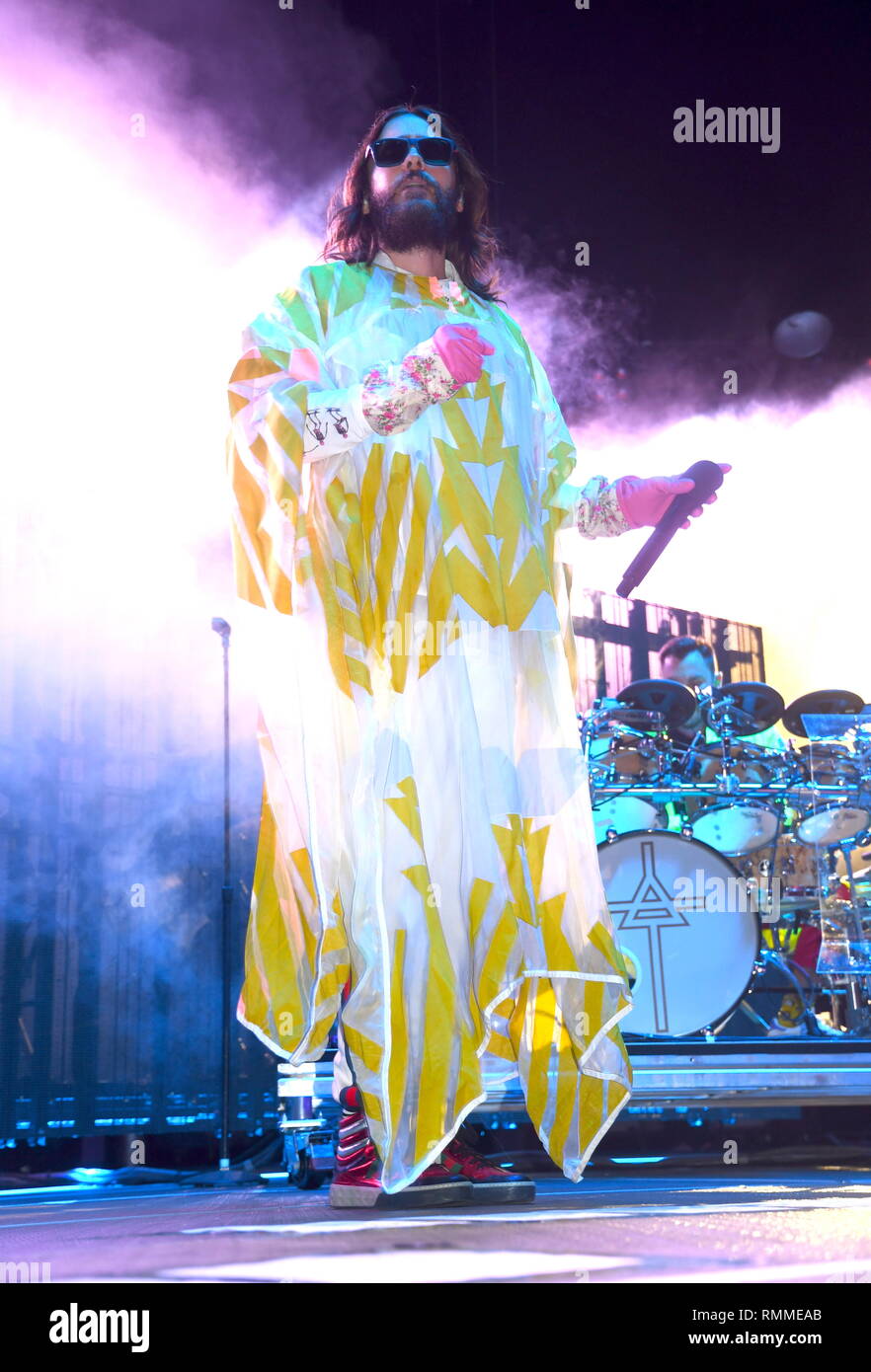 Jared Leto is shown performing on stage during a live concert ...